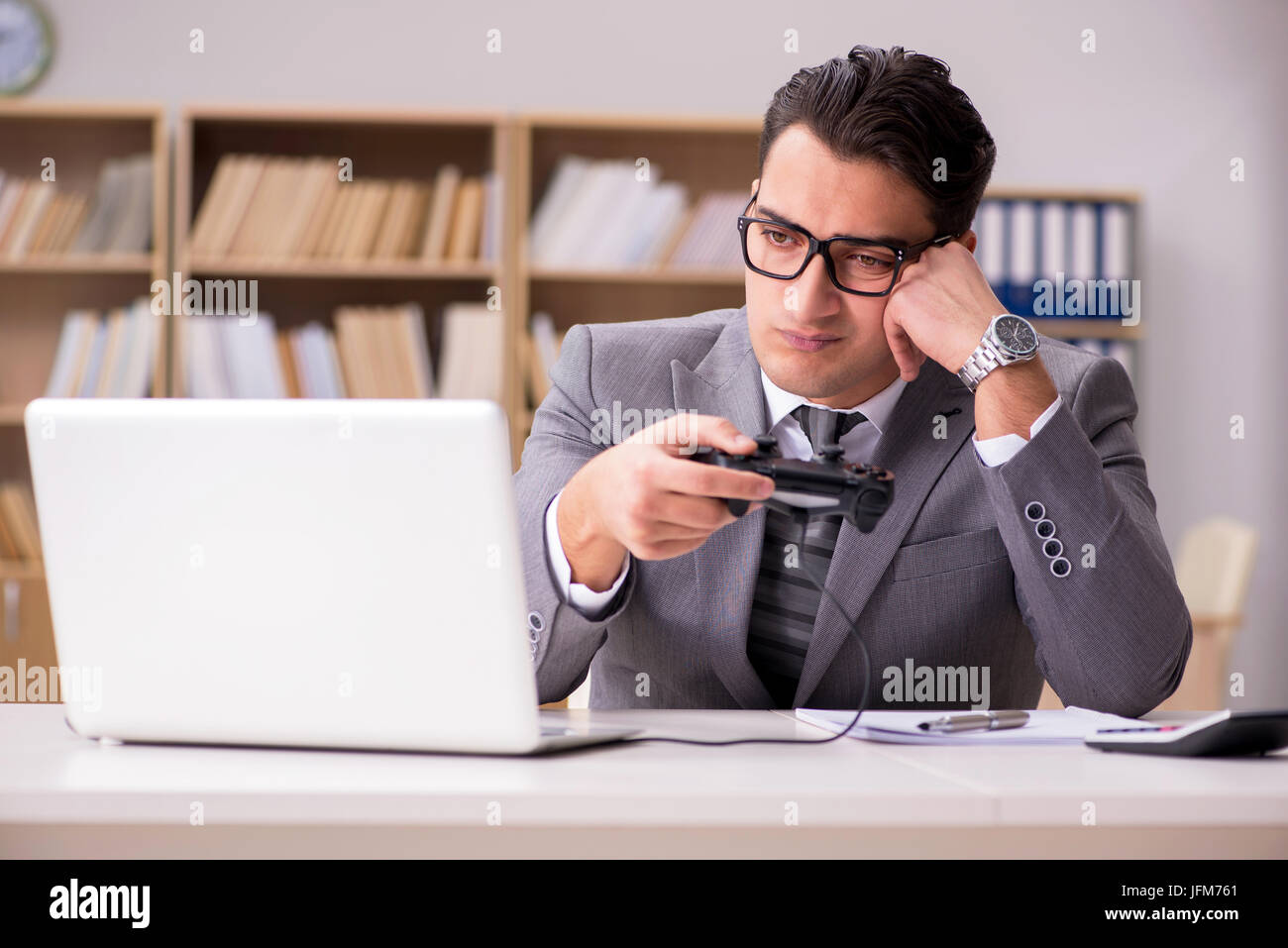 Businessman playing computer games at work office Stock Photo - Alamy