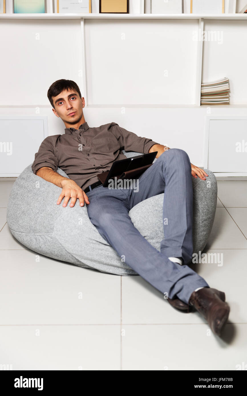 Businessman sitting relaxing on chair hi-res stock photography and ...