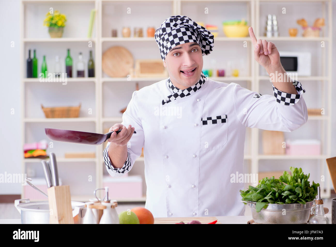 Young male cook working in the kitchen Stock Photo - Alamy