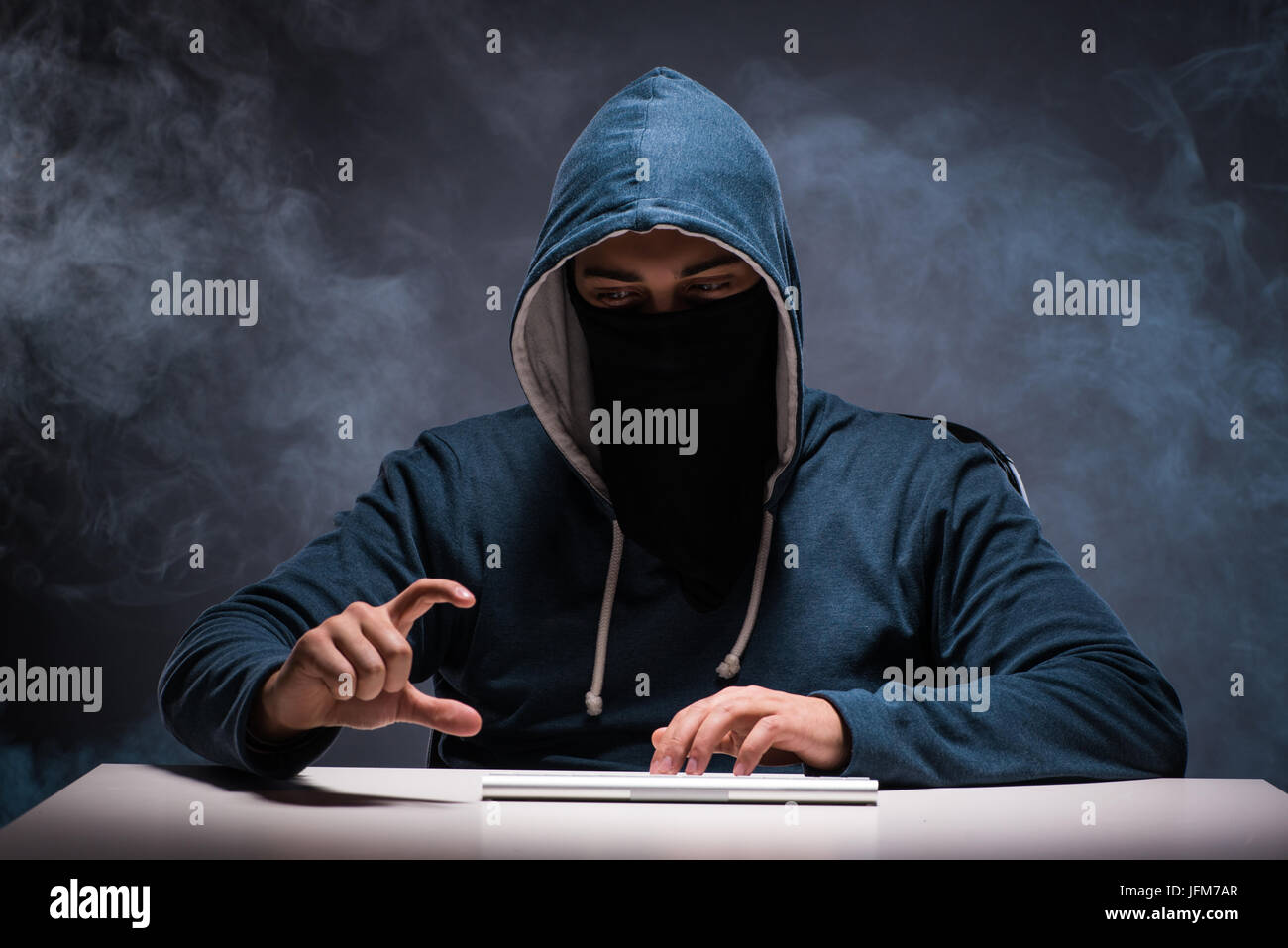 Computer hacker working in dark room Stock Photo - Alamy