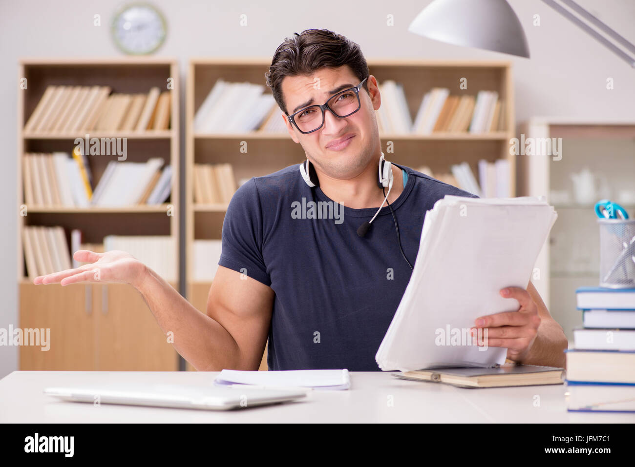 Unhappy student with too much to study Stock Photo - Alamy