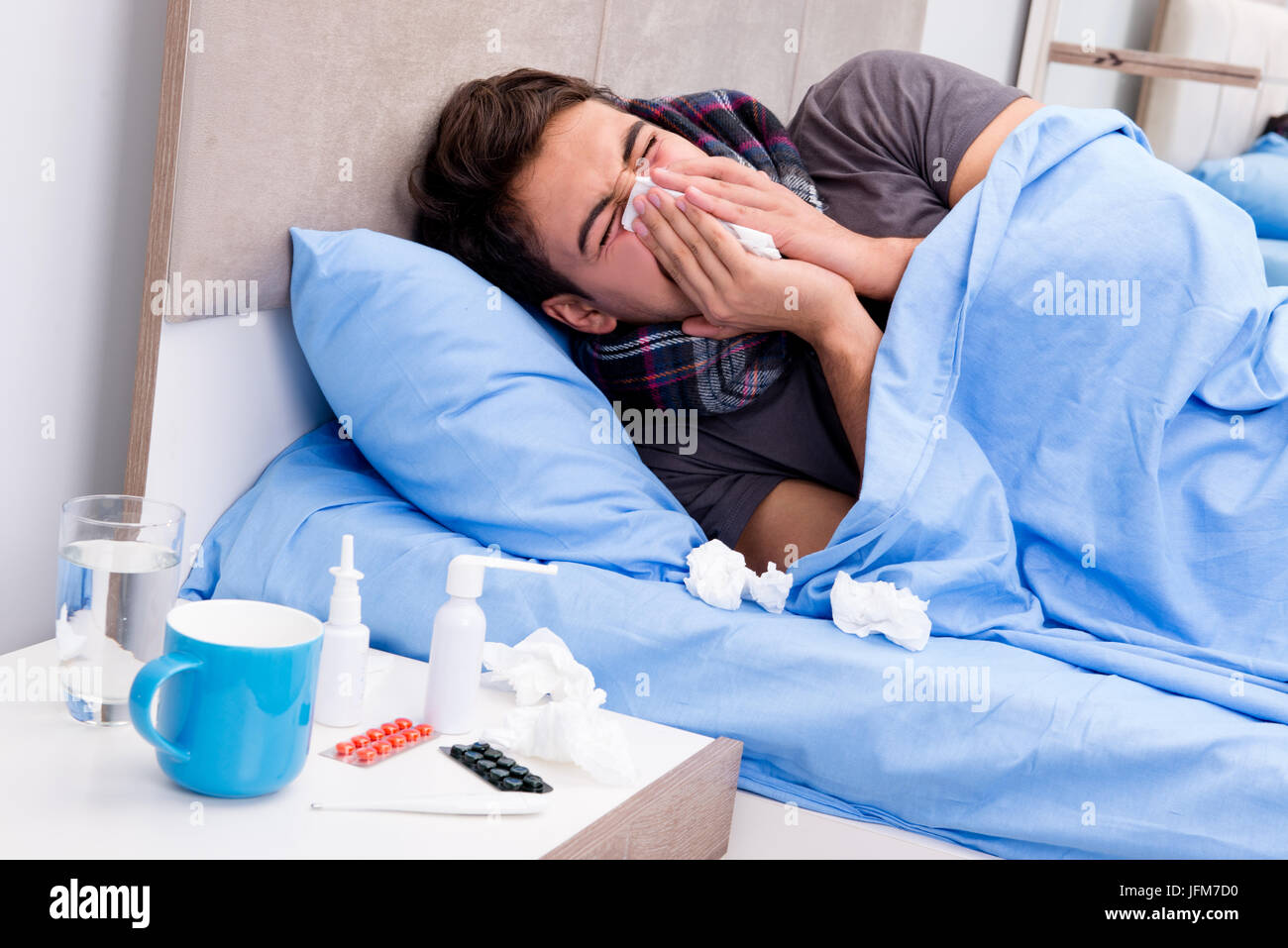Sick ill man in the bed taking medicines and drugs Stock Photo - Alamy
