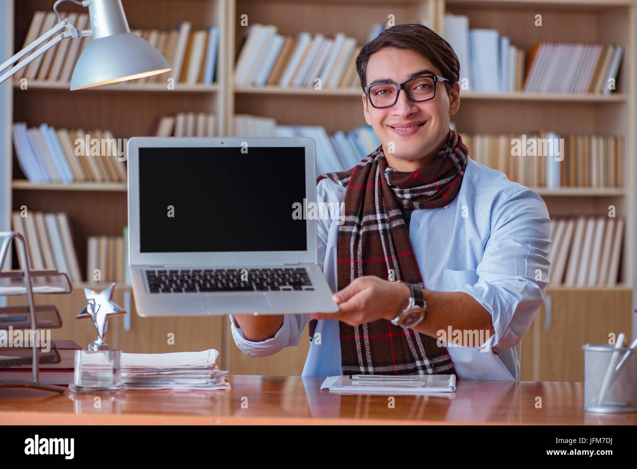Young book writer writing in library Stock Photo - Alamy