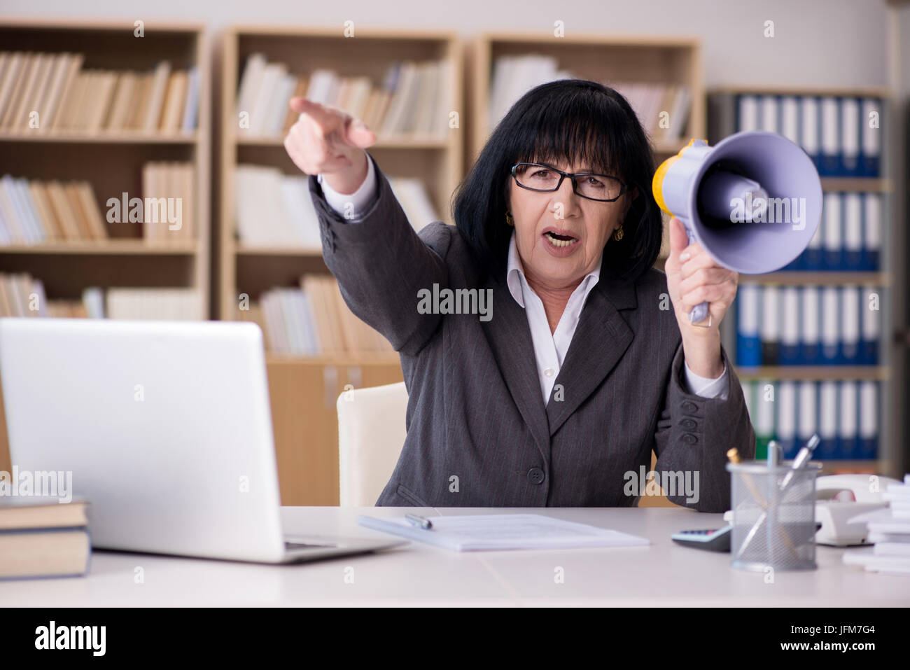 Angry businesswoman shouting with loudspeaker Stock Photo - Alamy