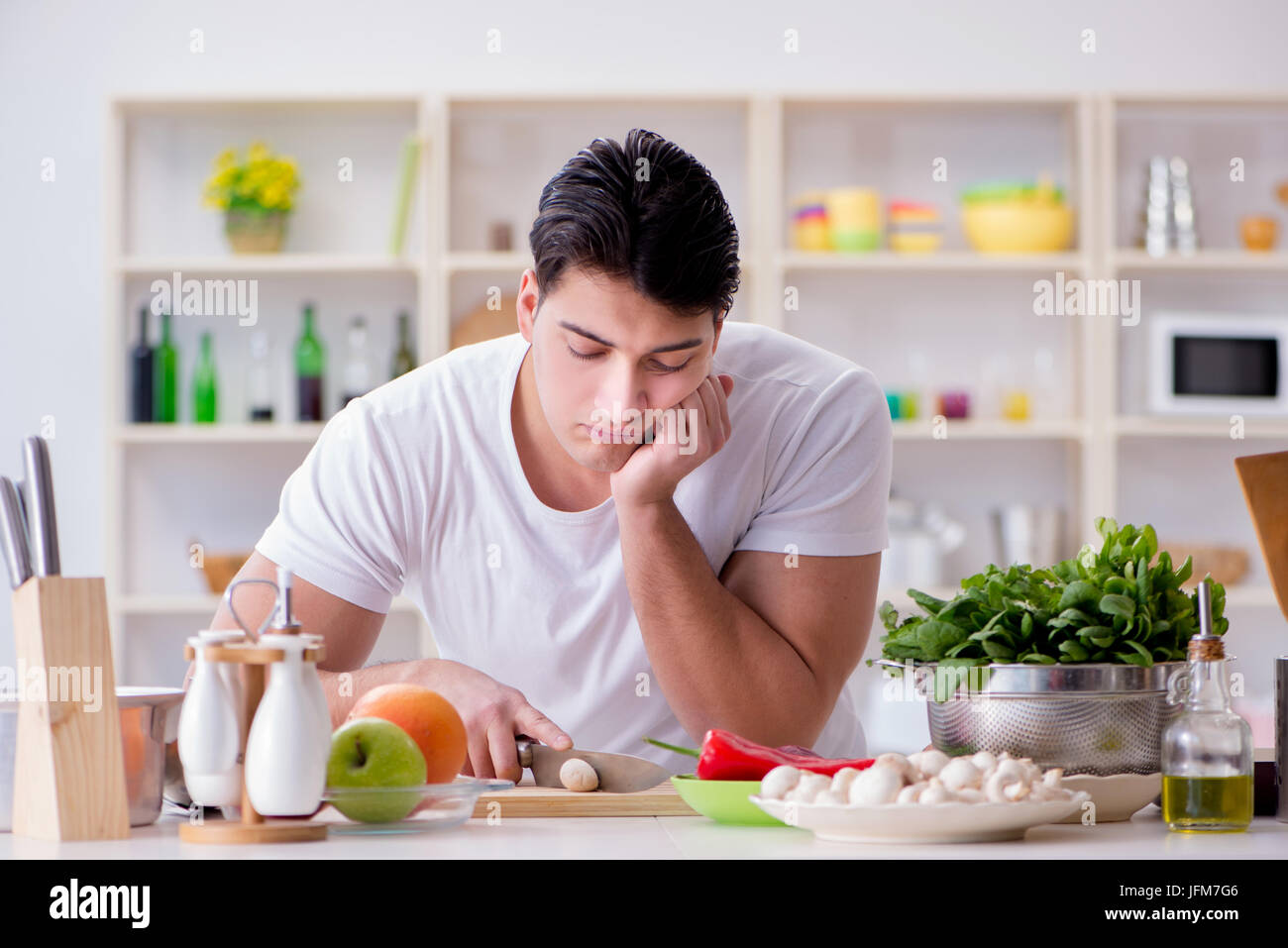Young male cook working in the kitchen Stock Photo - Alamy