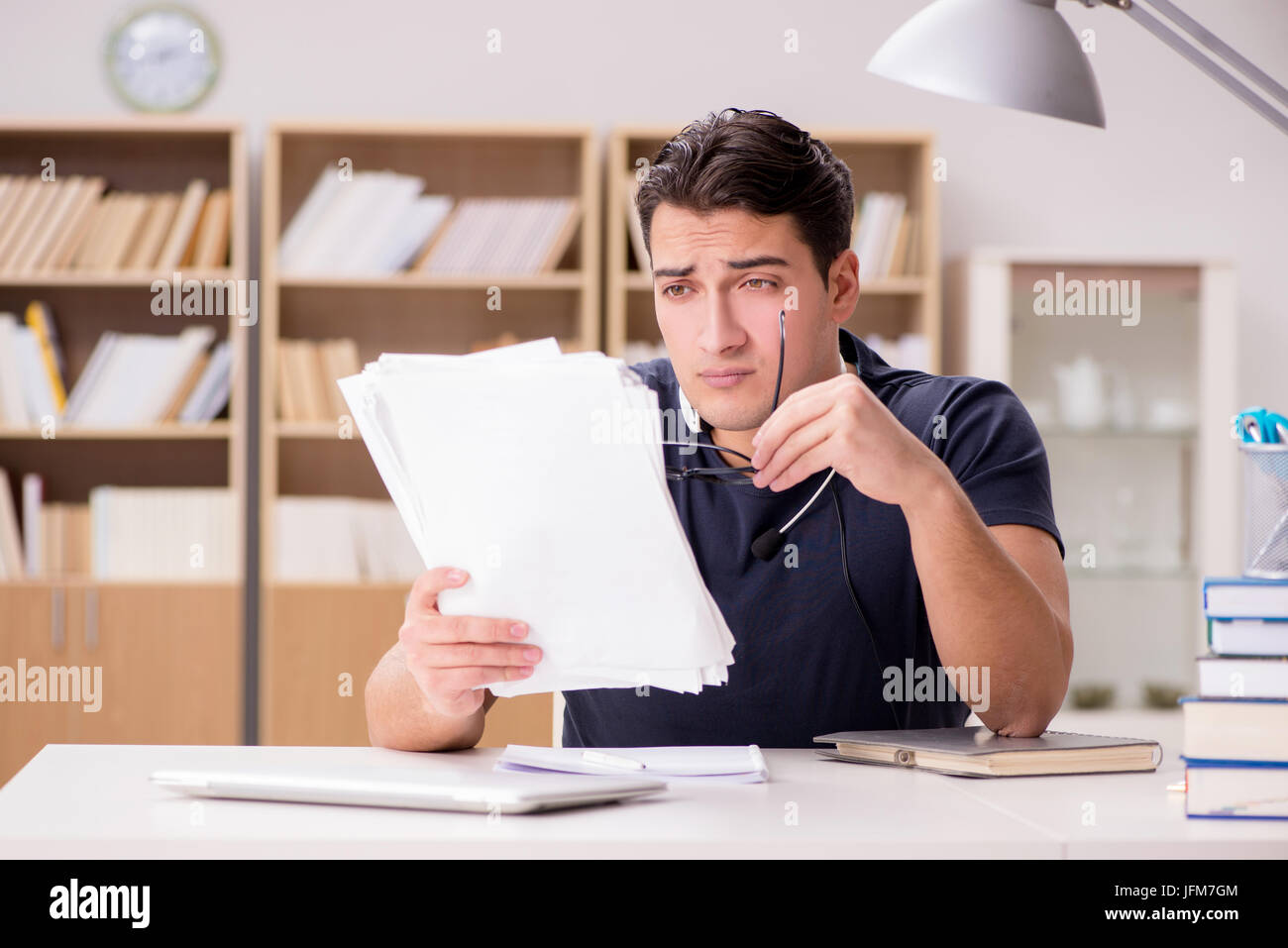 Angry man with too much paperwork to do Stock Photo - Alamy