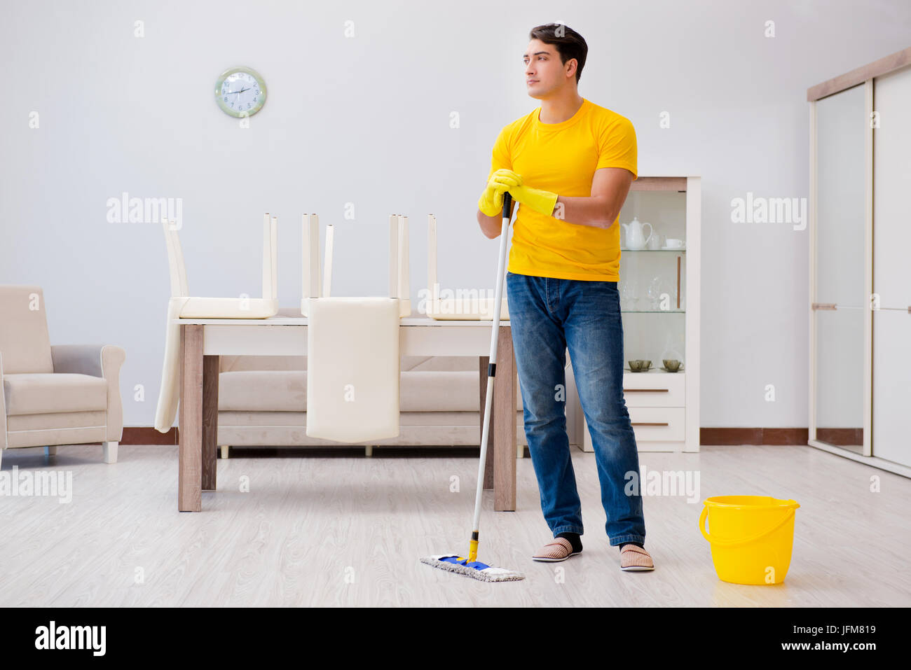 Man cleaning the house helping his wife Stock Photo - Alamy
