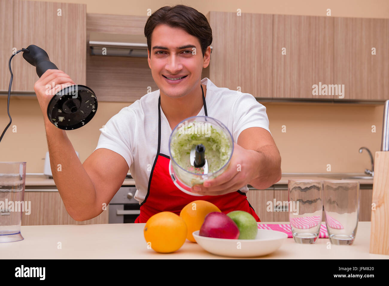 Handsome man working at the kitchen Stock Photo - Alamy