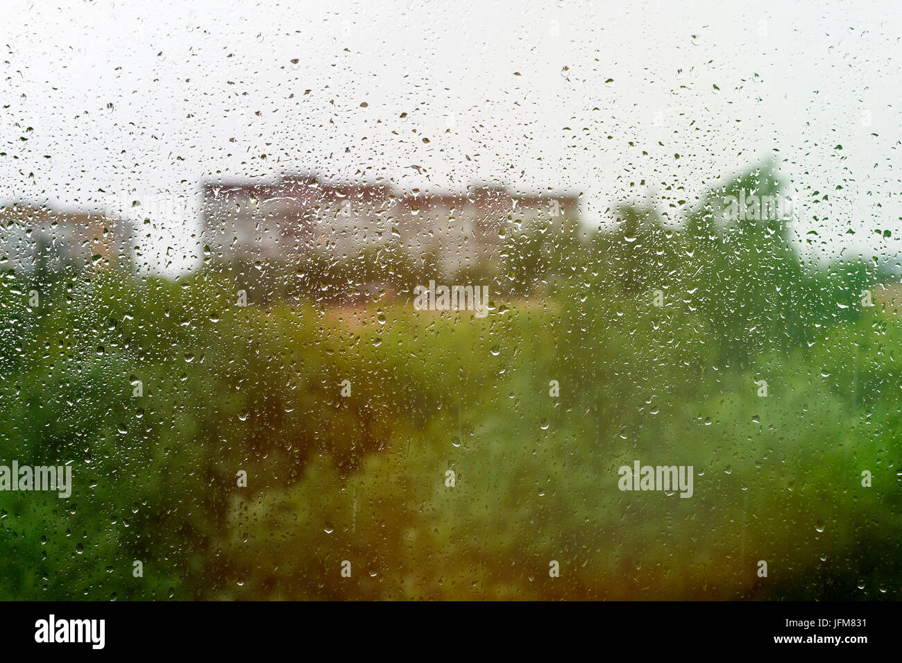Wet window with drops, view out apartment window nature Stock Photo - Alamy