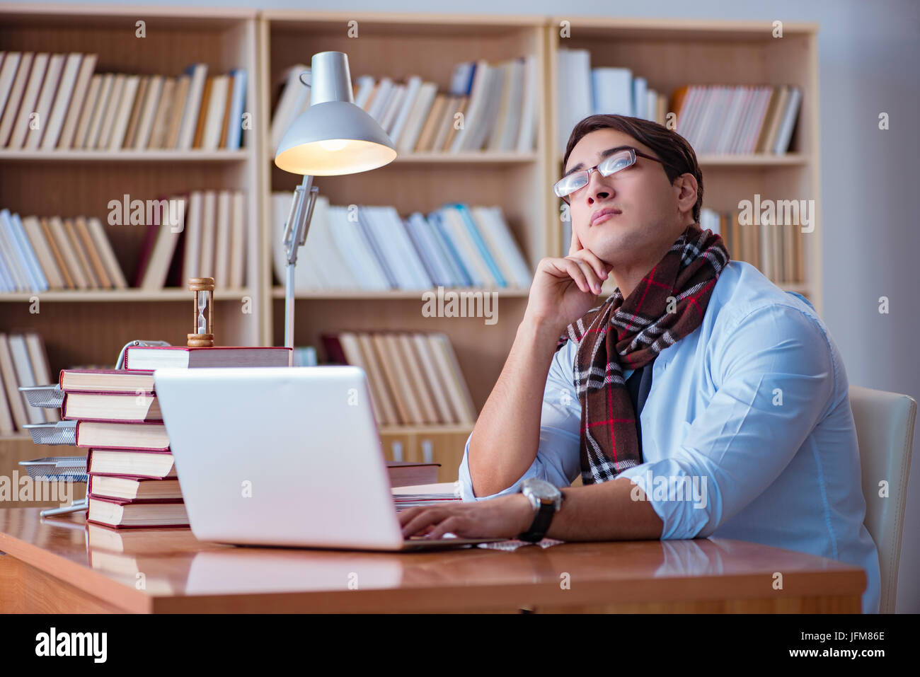 Young book writer writing in library Stock Photo - Alamy