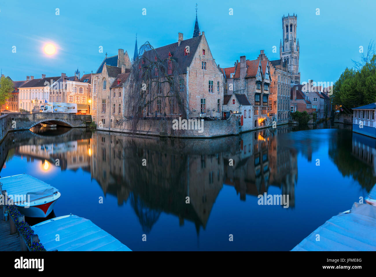 The medieval Belfry and historic buildings are reflected in ...