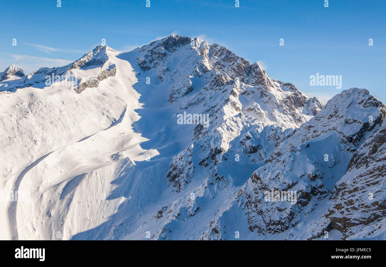 Aerial view of the snowy summit of Mount Disgrazia Masino Valley ...