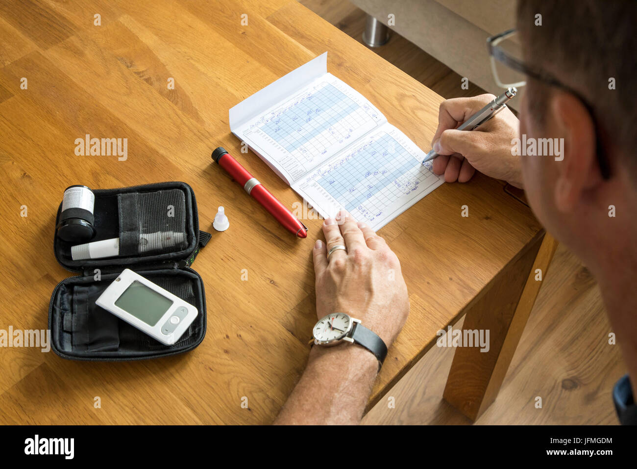 Diabetic make notes in his blood glucose test book, notes about blood ...