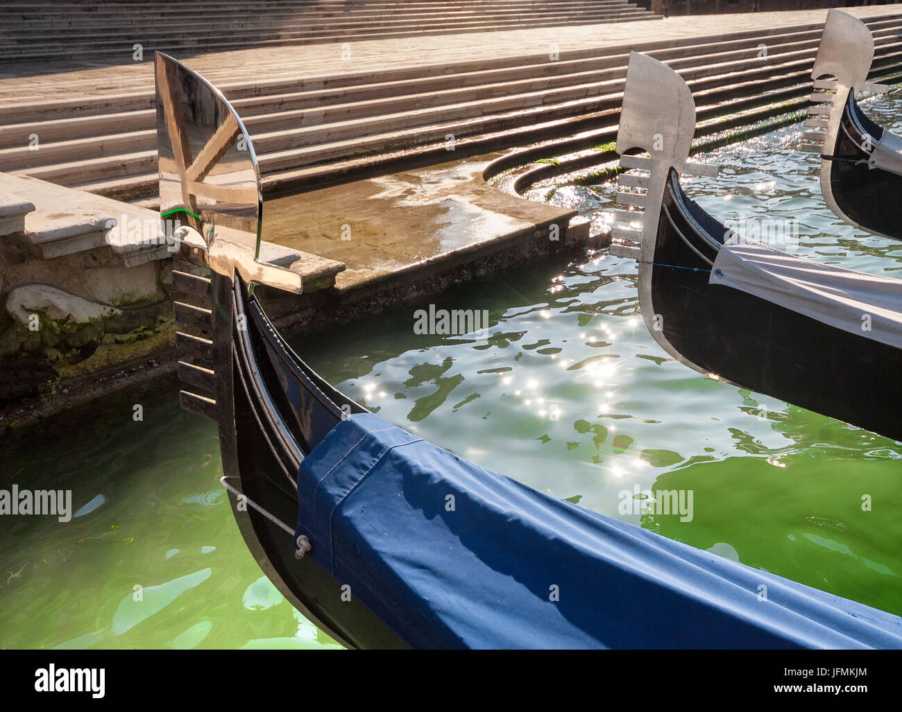 Three gondolas moored at the St. Mark's square jetty on the Grand Canal ...