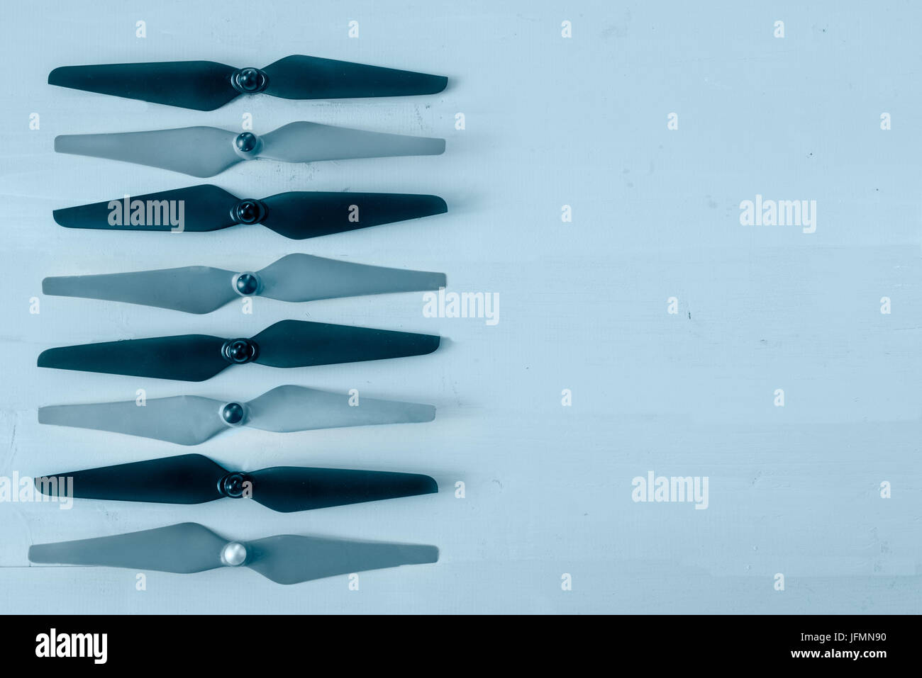 Top view of drone propellers, on a rusty blue background wooden table ...