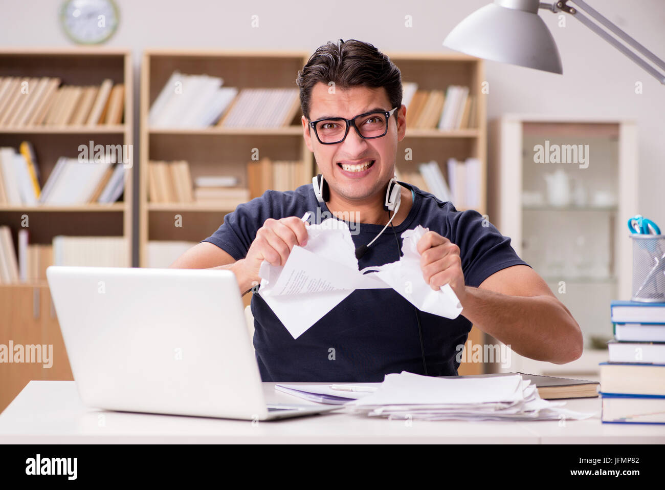 Angry man tearing apart his paperwork due to stress Stock Photo - Alamy