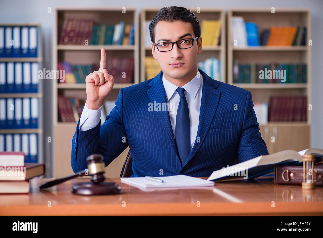 Handsome judge with gavel sitting in courtroom Stock Photo - Alamy