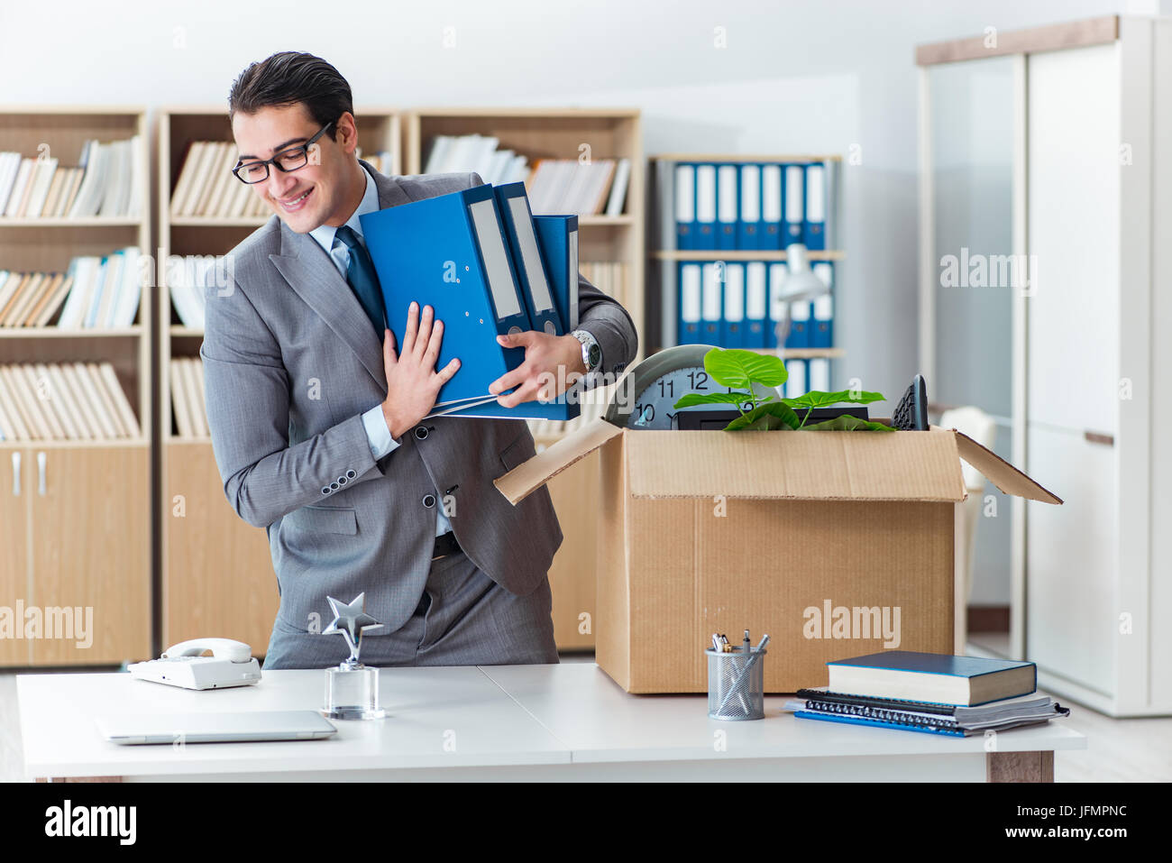 Man moving office with box and his belongings Stock Photo - Alamy