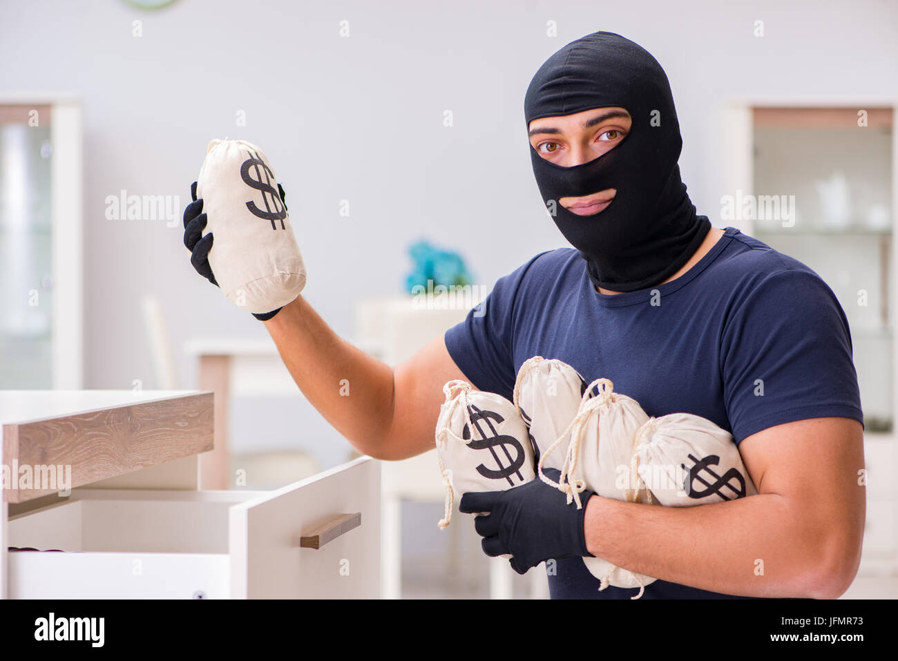 Robber wearing balaclava stealing valuable things Stock Photo - Alamy