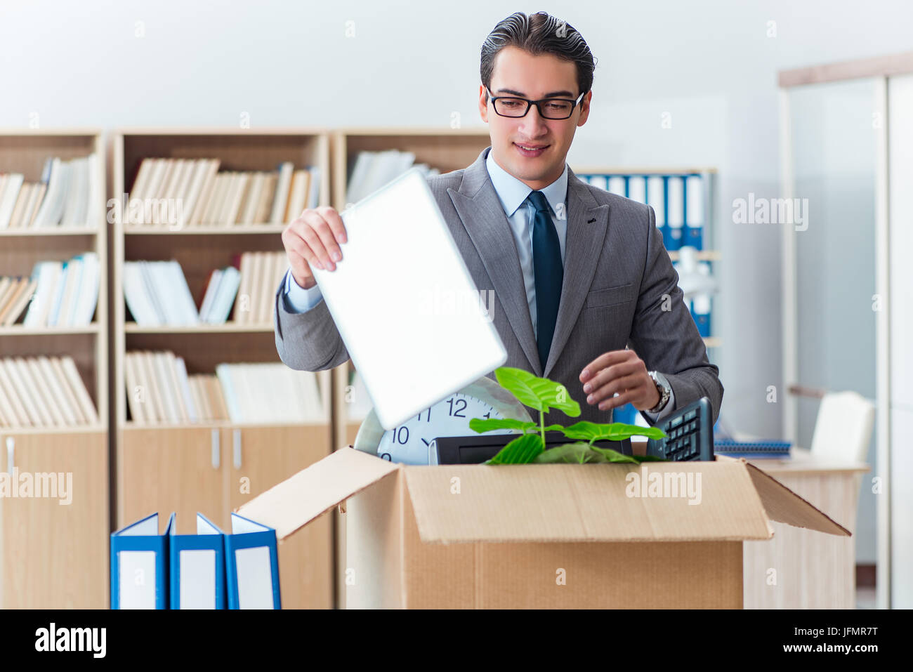 Man moving office with box and his belongings Stock Photo - Alamy