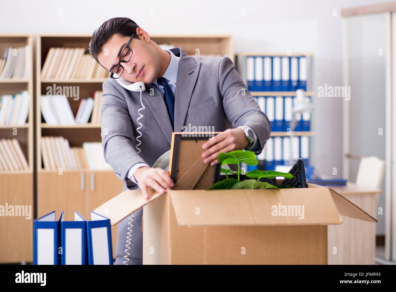Young businessman moving offices after being made redundant Stock Photo ...