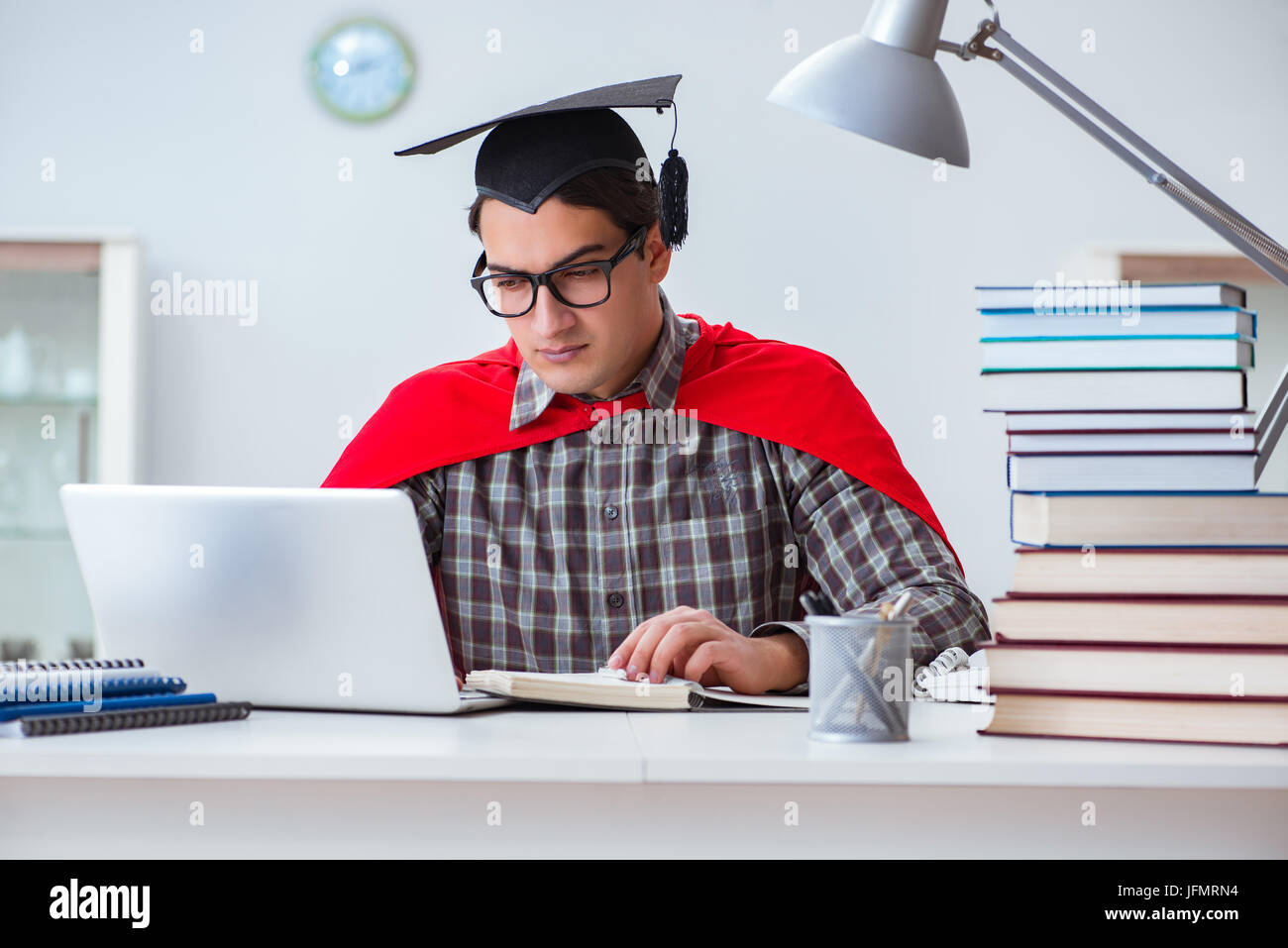 Super hero student with books studying for exams Stock Photo - Alamy