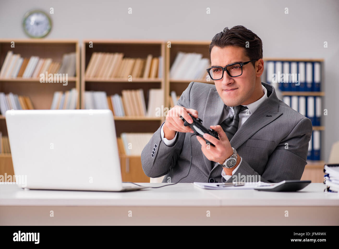 Businessman playing computer games at work office Stock Photo - Alamy