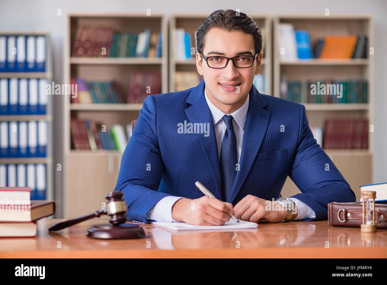 Handsome judge with gavel sitting in courtroom Stock Photo - Alamy