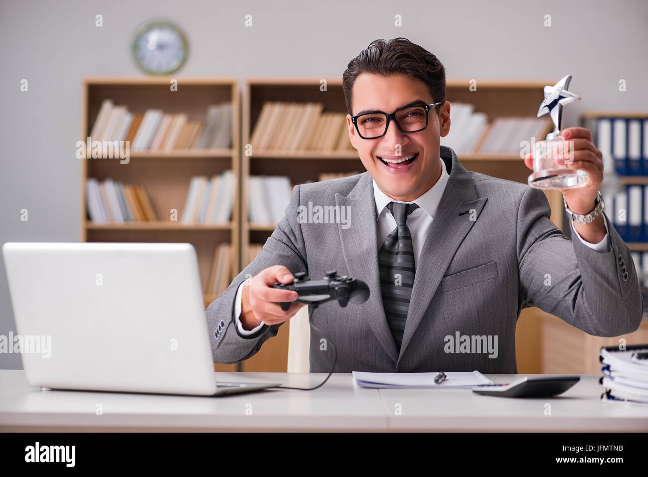 Businessman playing computer games at work office Stock Photo - Alamy