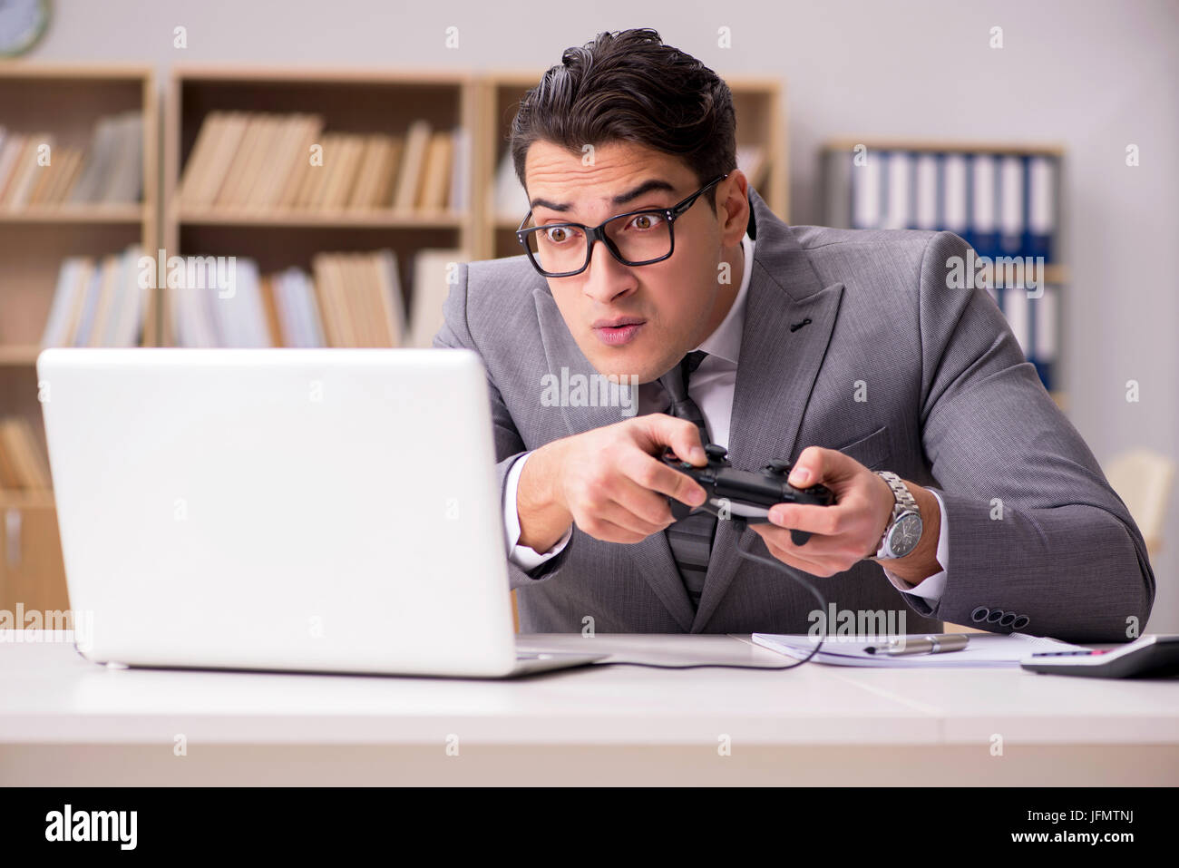 Businessman playing computer games at work office Stock Photo - Alamy