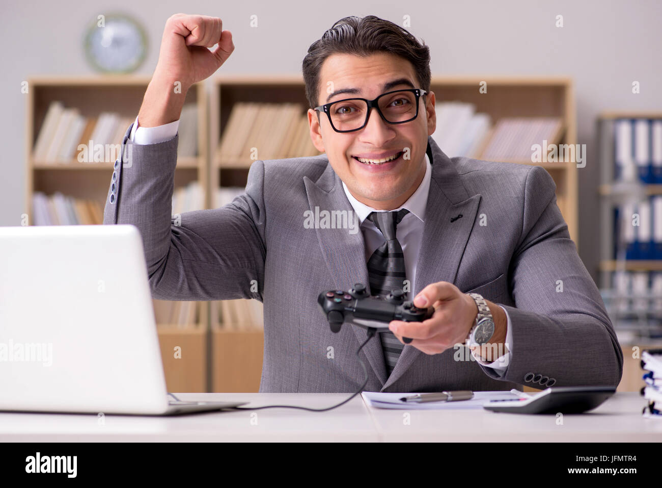 Businessman playing computer games at work office Stock Photo - Alamy