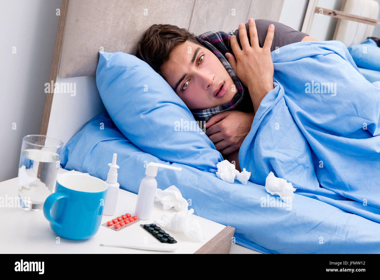 Sick ill man in the bed taking medicines and drugs Stock Photo - Alamy