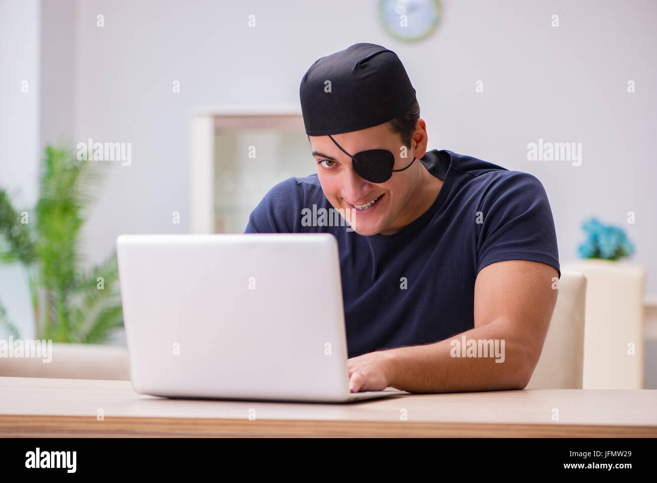 Digital security concept with pirate at computer Stock Photo - Alamy