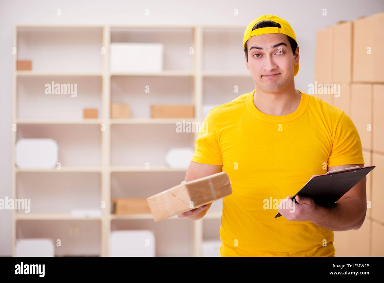 Man working in postal parcel delivery service office Stock Photo - Alamy