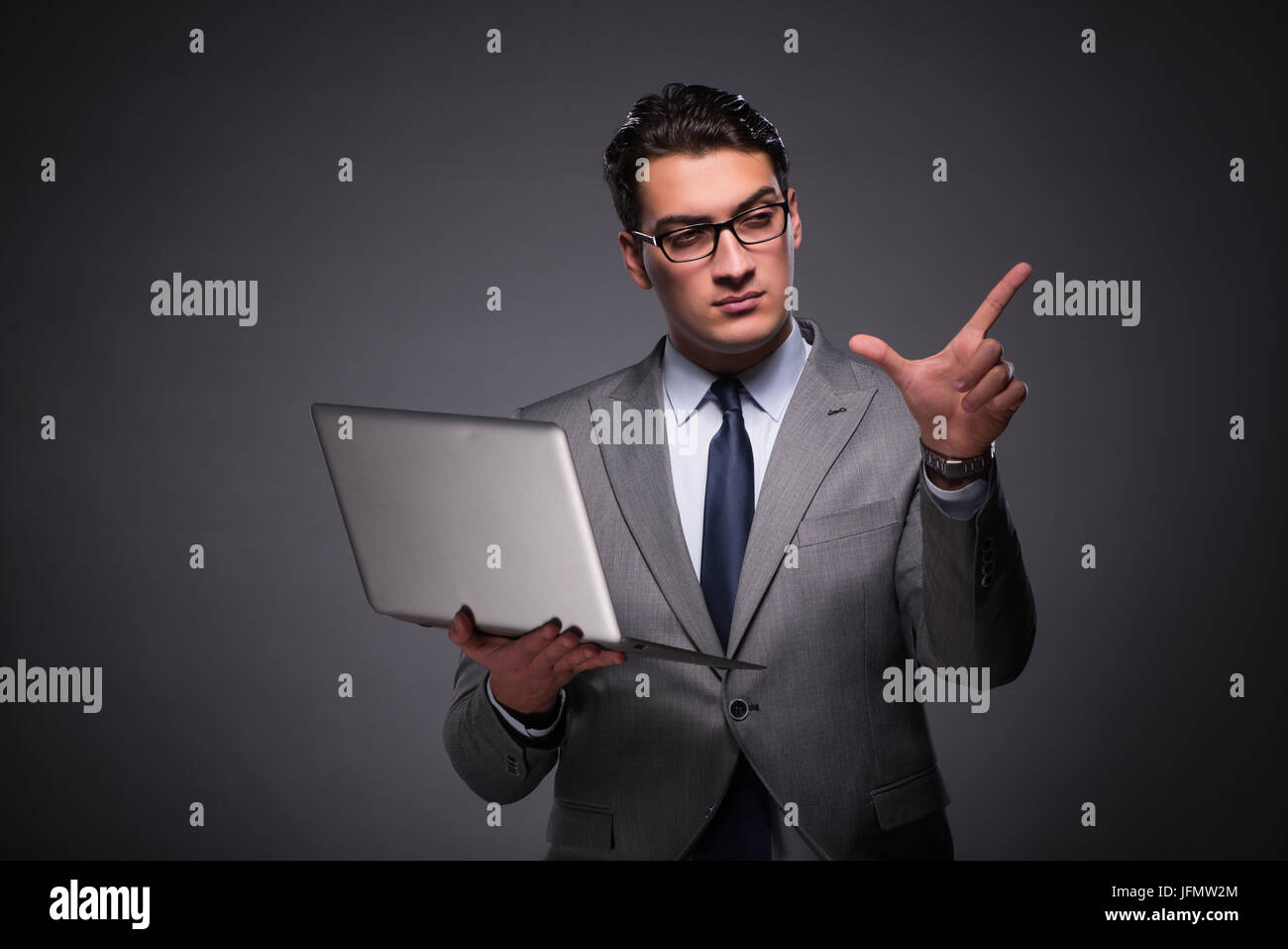 Handsome businessman working on laptop computer Stock Photo - Alamy