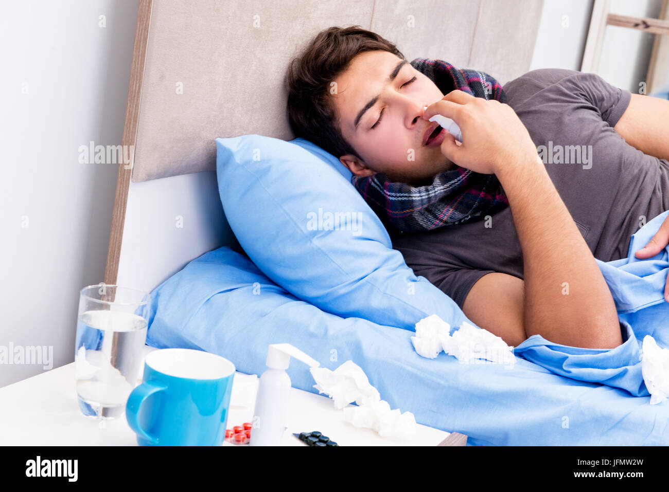 Sick ill man in the bed taking medicines and drugs Stock Photo - Alamy