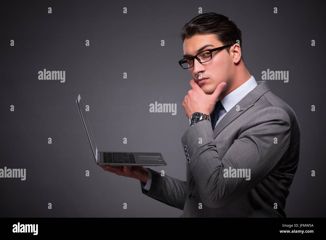 Handsome businessman working on laptop computer Stock Photo - Alamy