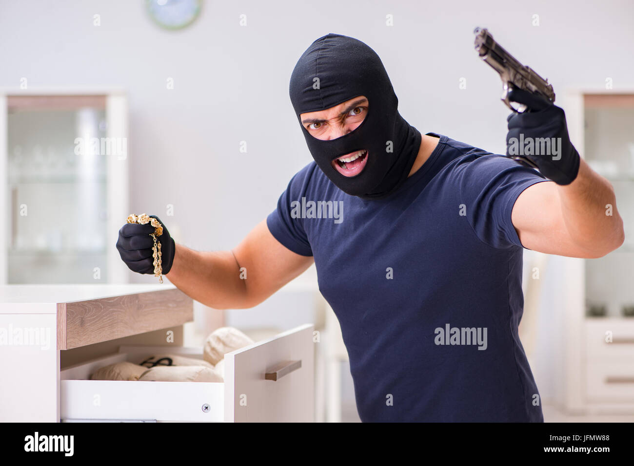 Robber wearing balaclava stealing valuable things Stock Photo - Alamy