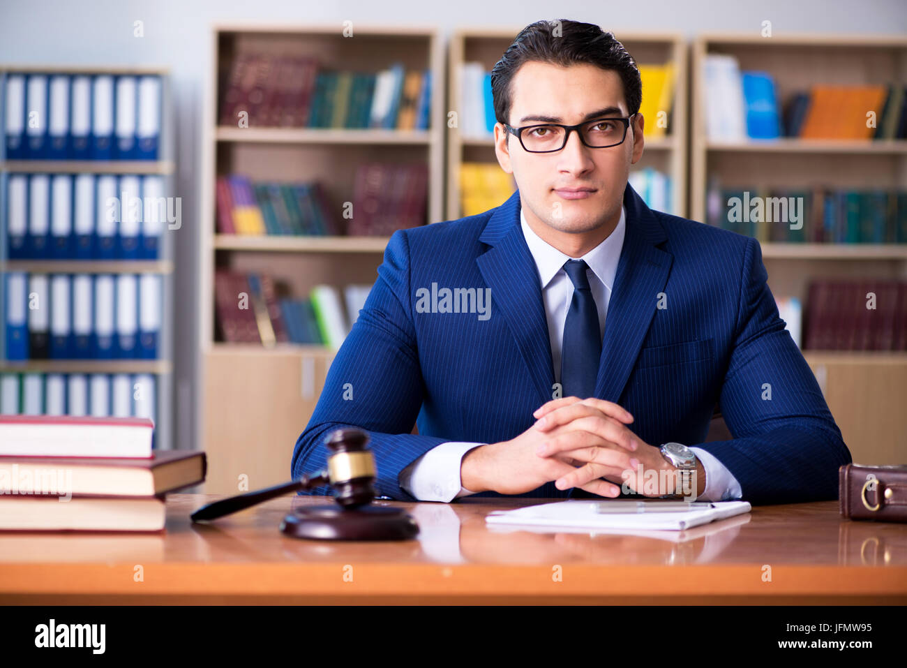 Handsome judge with gavel sitting in courtroom Stock Photo - Alamy