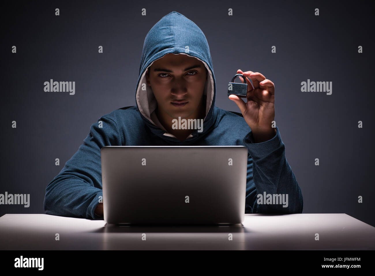 Computer hacker working in dark room Stock Photo - Alamy