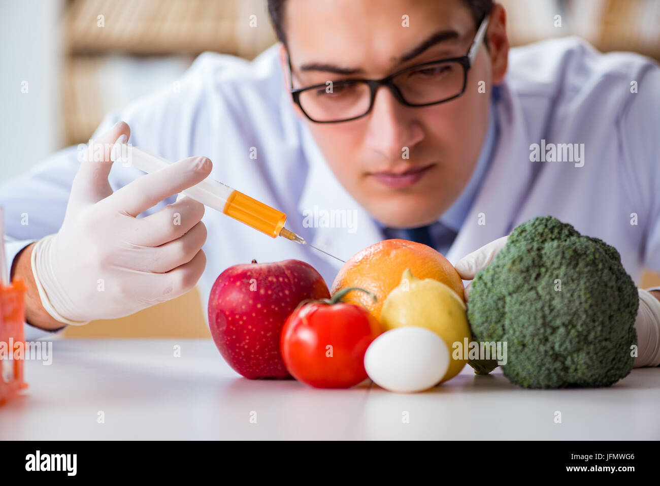 Man doctor checking the fruits and vegetables Stock Photo - Alamy