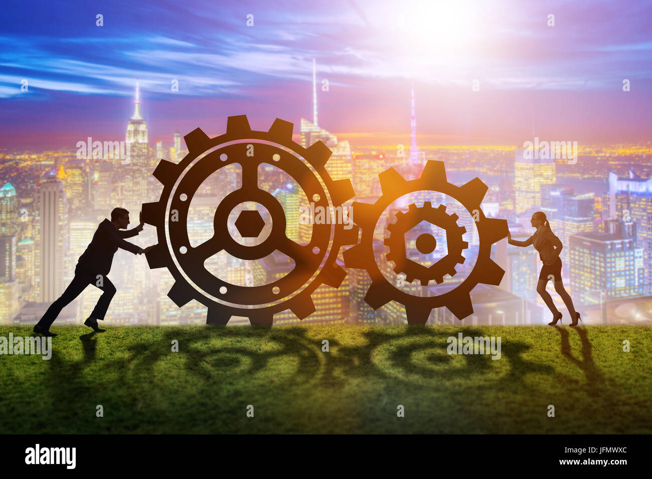 Businesspeople in teamwork example with cogwheels Stock Photo - Alamy