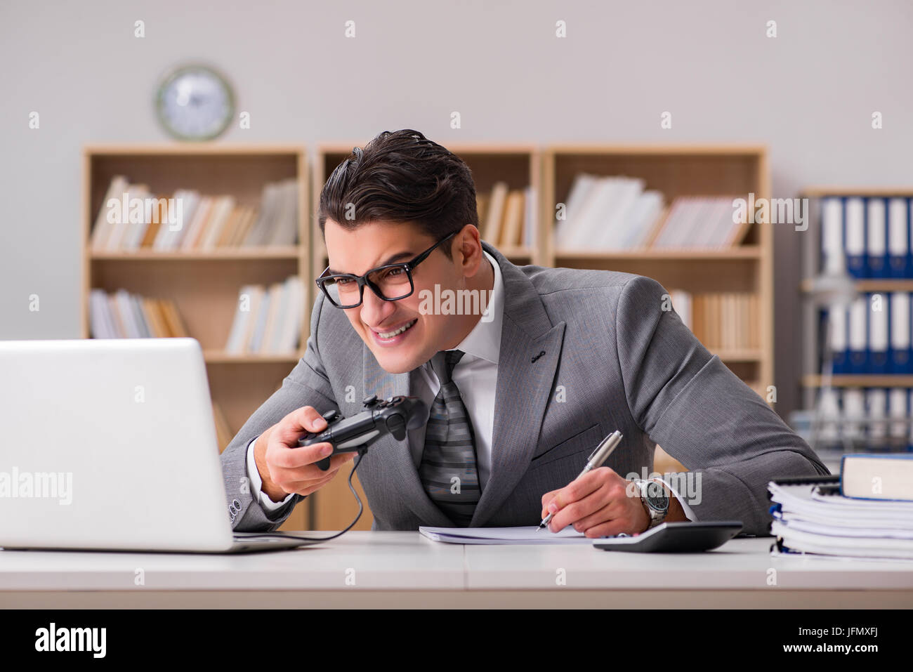 Businessman playing computer games at work office Stock Photo - Alamy