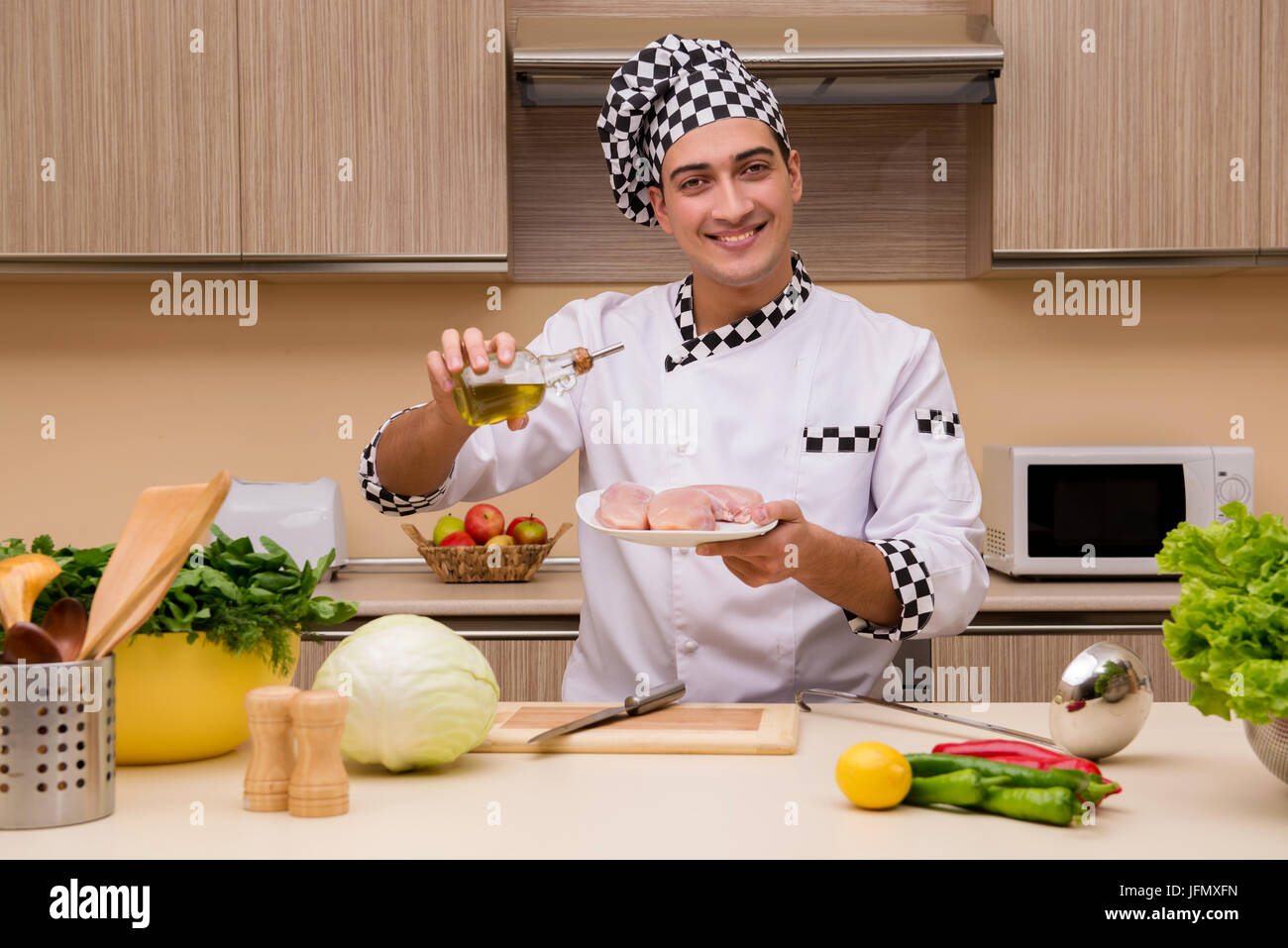 Young chef working in the kitchen Stock Photo - Alamy