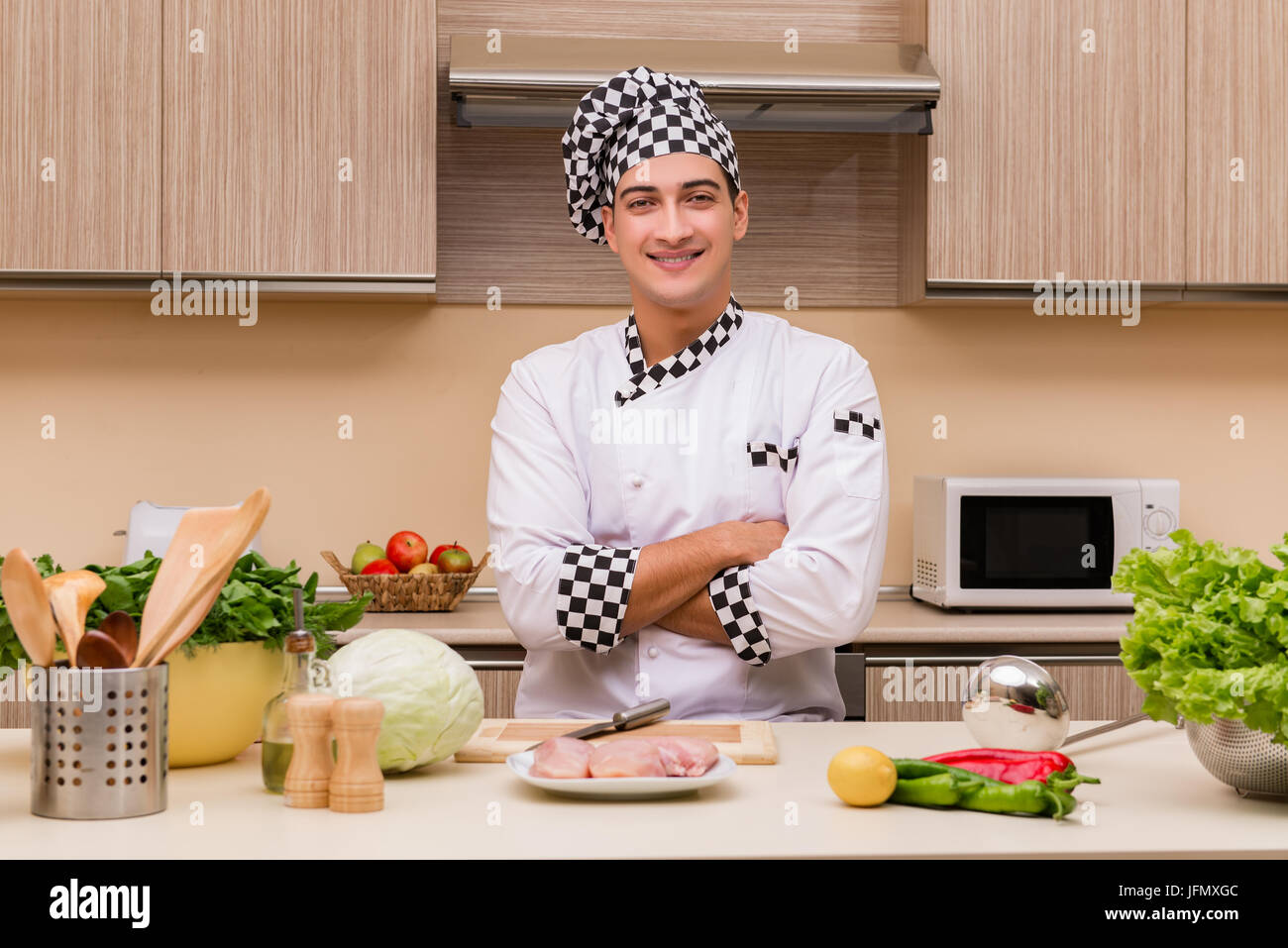 Young chef working in the kitchen Stock Photo - Alamy