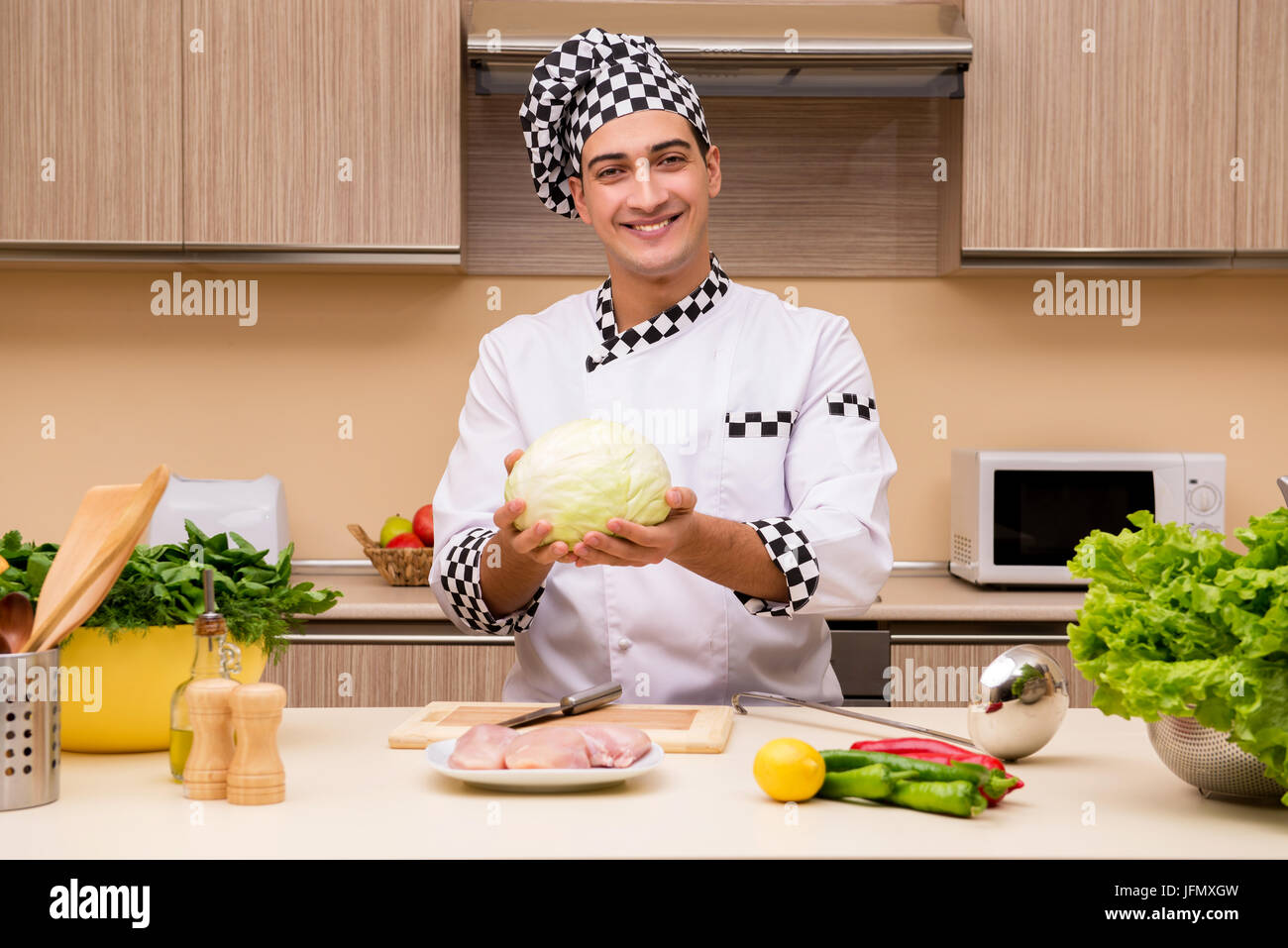 Young chef working in the kitchen Stock Photo - Alamy