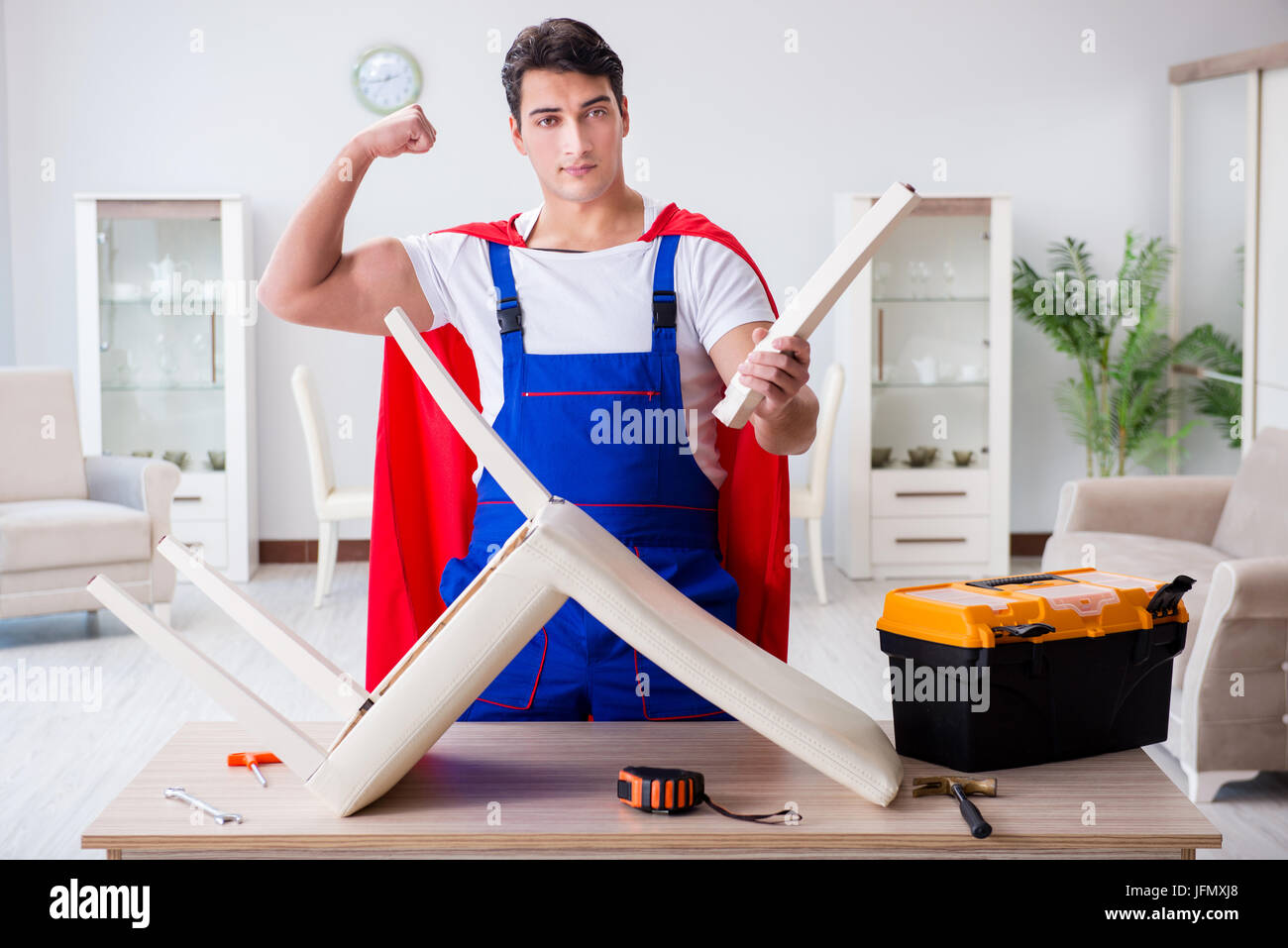 Superhero repairman with tools in repair concept Stock Photo - Alamy