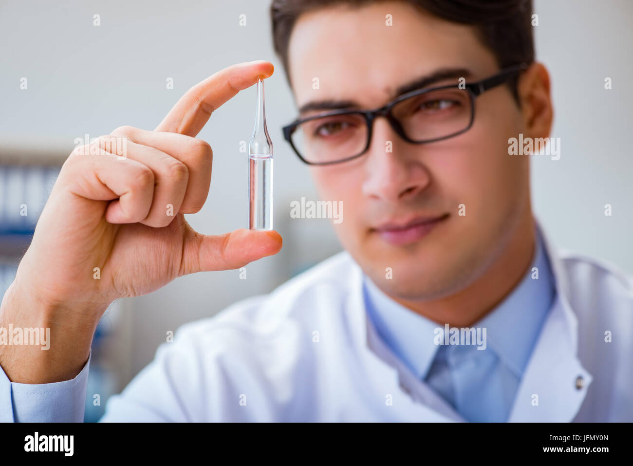 Doctor holding medicines in the lab Stock Photo - Alamy