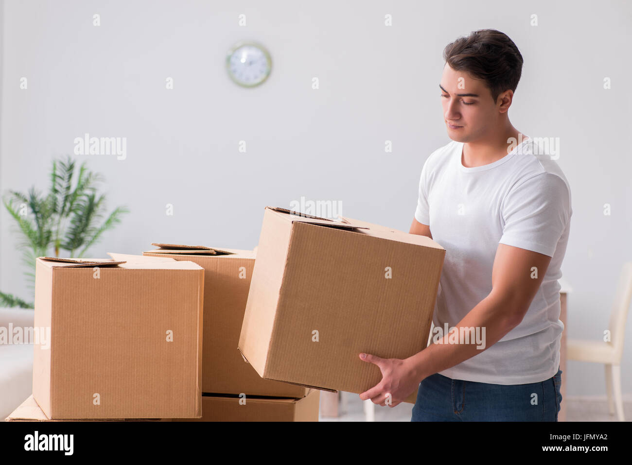 The man carrying boxes at home Stock Photo - Alamy