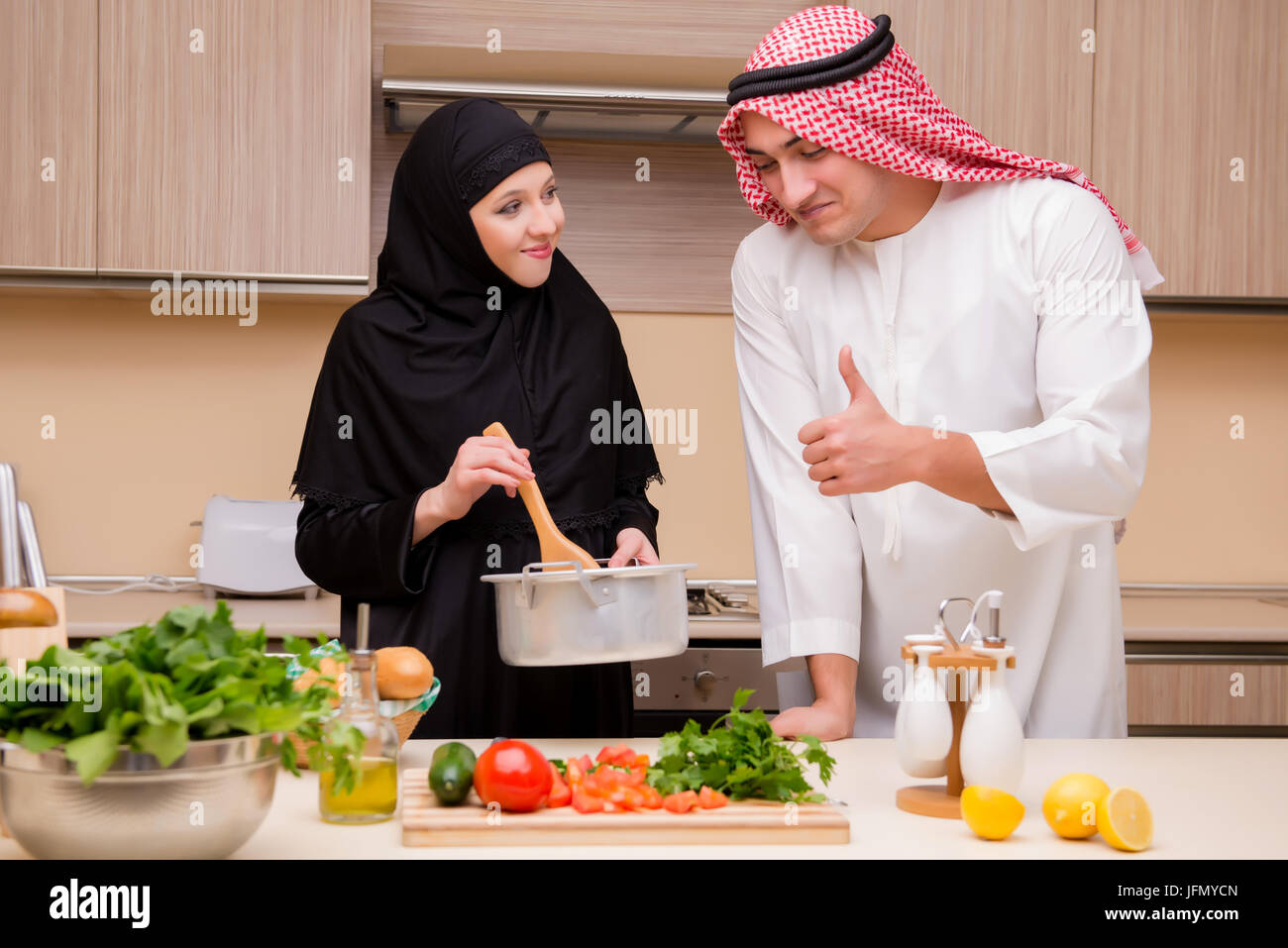 The young arab family in the kitchen Stock Photo - Alamy